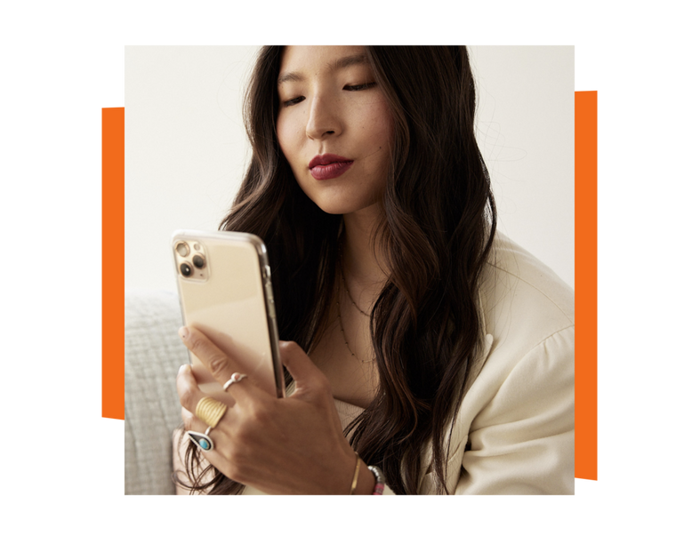 Woman on her phone using the Ulta Beauty Mobile App.